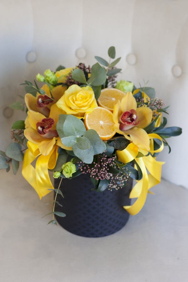 Black Hat Box with Yellow Flowers on Light Background Stock Photo ...