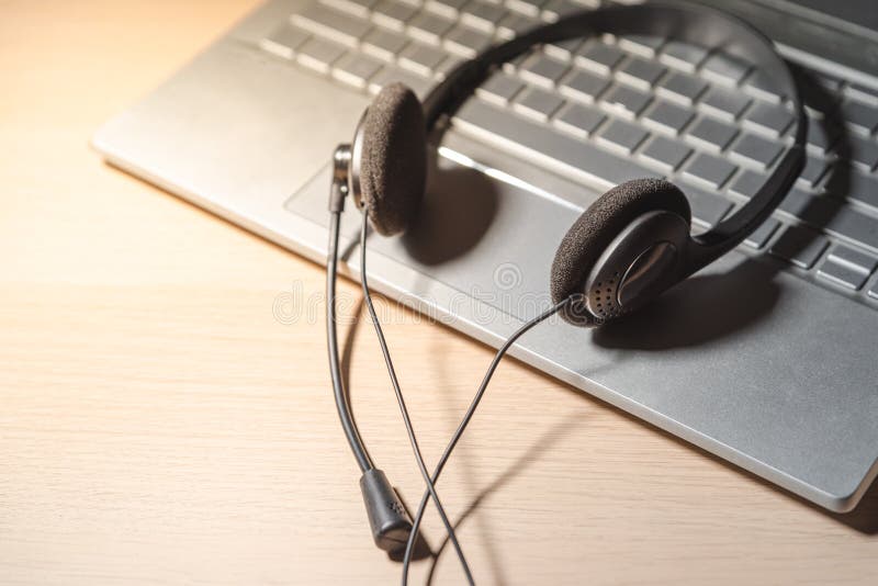 Black Headset on the Top of Matt Silver Modern Laptop Stock Photo ...