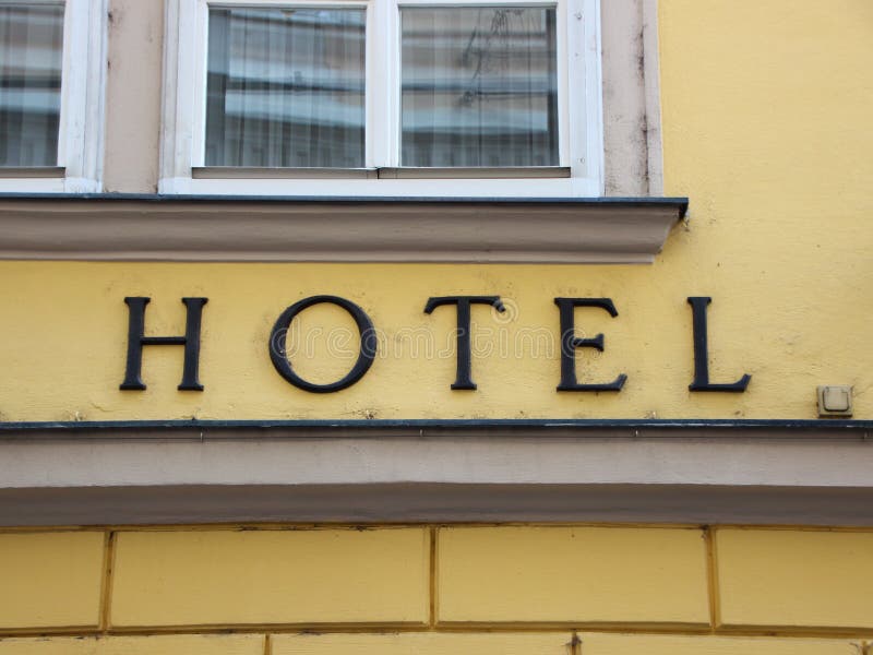 Black Hotel Text Sign on Yellow Building Stock Photo - Image of hotel ...