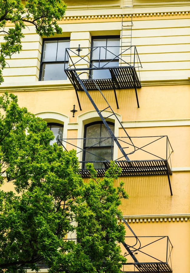 Black Iron Fire Escape on Yellow Building Stock Photo - Image of ...