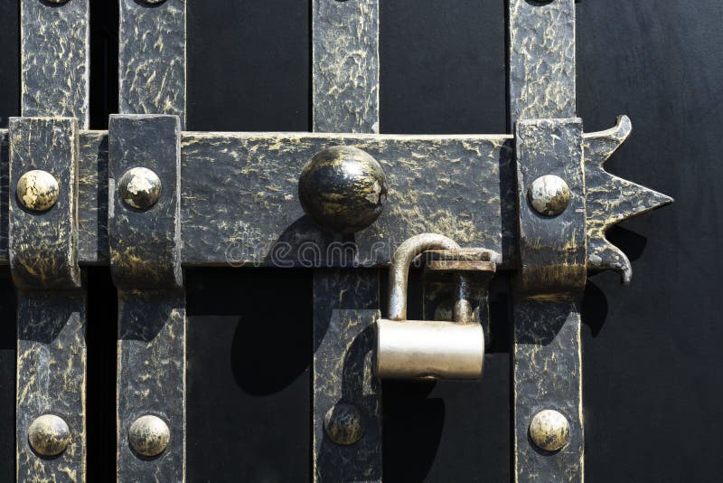Black Iron Gate, Brass Squares and a Lock with Latch Stock Photo ...