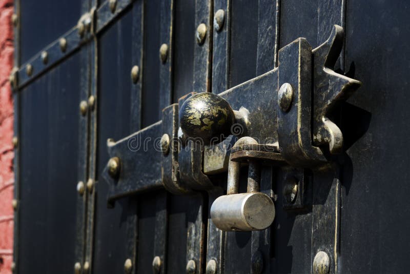 Black Iron Gate, Brass Squares and a Lock with Latch Stock Photo ...