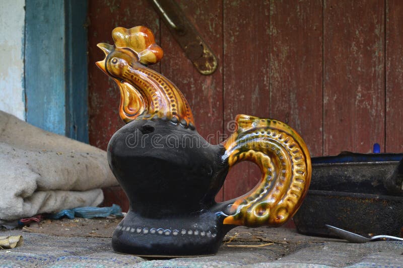 A Black Jug in the Shape of a Rooster Stands on the Table Stock Image ...