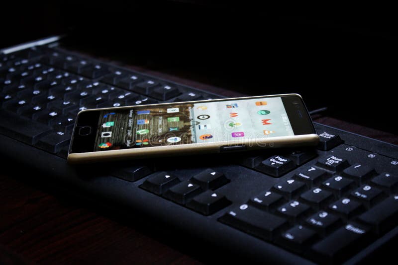 Black keyboard with mobile editorial stock image. Image of gadget ...