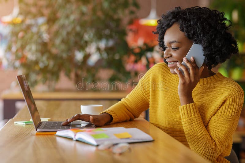 Black Lady Talking on Mobile Phone and Using Laptop Stock Image - Image ...