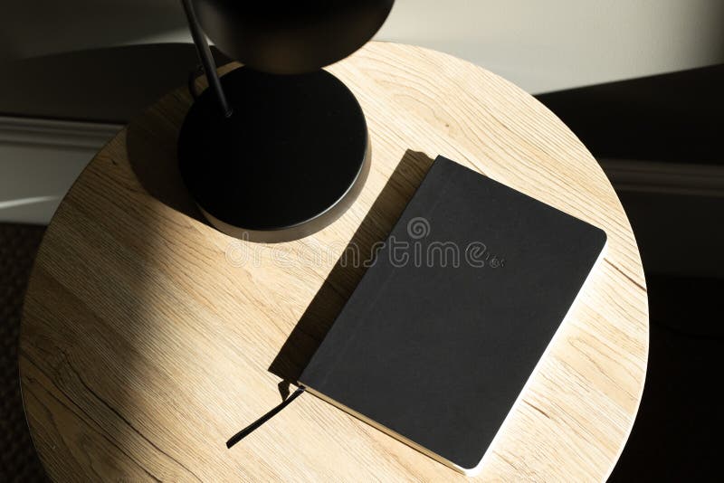 Black Lamp and Black Book on the Table with Sun Light Near Bed Stock ...