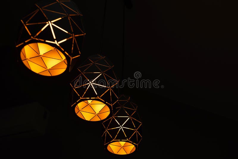 Black Lamps with a Geometric Pattern, Three Lamps on a Black Background ...