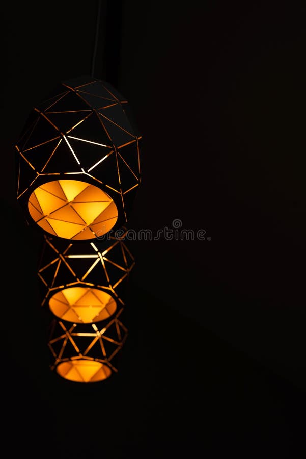 Black Lamps with a Geometric Pattern, Three Lamps on a Black Background ...