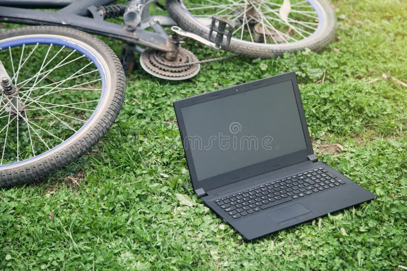 Black Laptop with Bicycle on Grass Stock Photo - Image of business ...