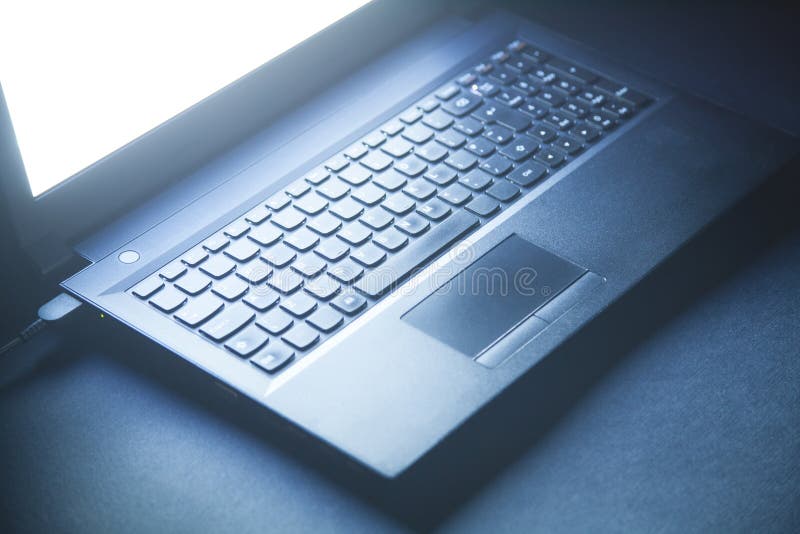 Black Laptop on the Black Office Desk. Technology Concept Stock Photo ...