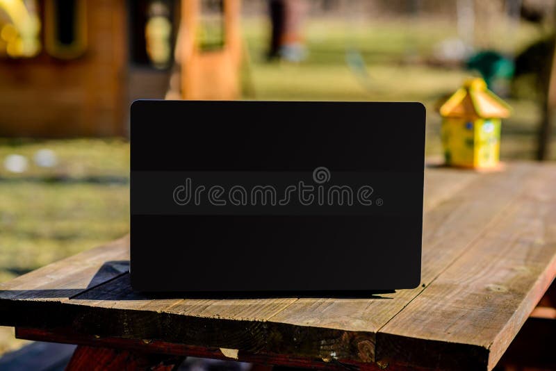 Black Laptop on Picnic Table Outdoors Stock Photo - Image of jzaring ...