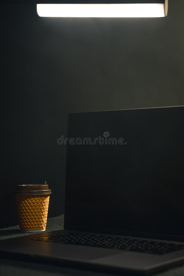 Black Laptop Screen and a Cup of Coffee in a Dark Room. Stock Image ...