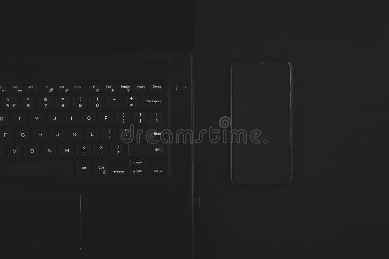 Black Laptop and Black Smartphone on Black Table. Dark Theme Stock ...