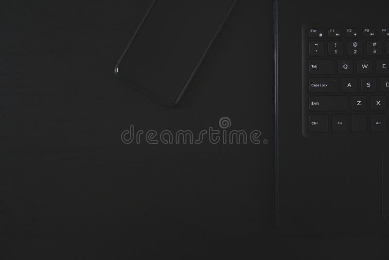 Black Laptop and Black Smartphone on Black Table. Dark Theme Stock ...