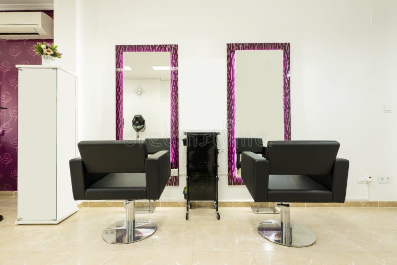 Black Leather Sofas in a Beauty Salon with Rectangular Mirrors on the ...