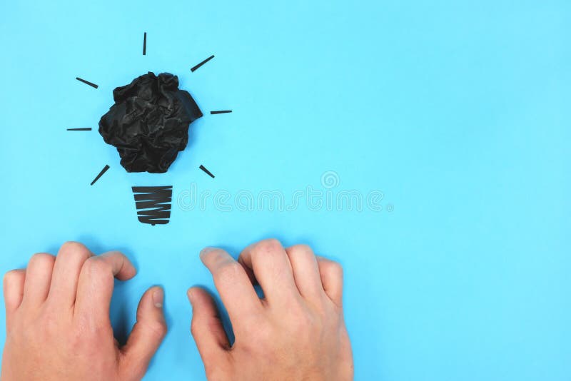 Black Light Bulb with Hands Flat Lay in Blue Background. Drained Brain ...