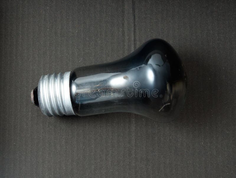 A Black Light Bulb is Sitting on a Black Background Stock Image - Image ...