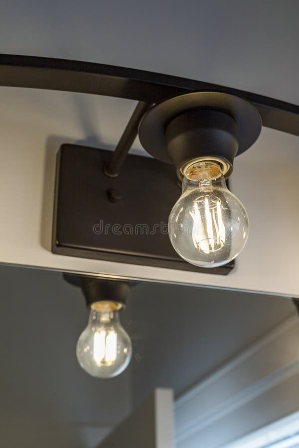 A Black Light Fixture with Two Bulbs, One of Which is Lit Stock Photo ...