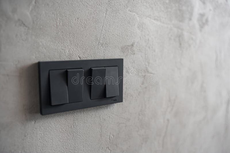 Black Light Switch Keys on a Gray Wall. Stock Image - Image of switch ...