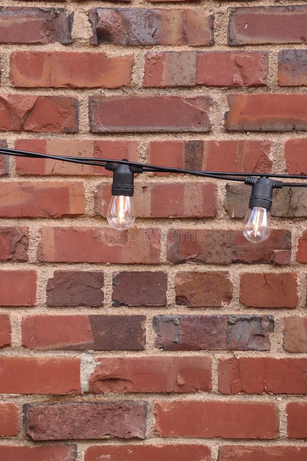 Black Lightbulb String on Bold Red Brick Stock Photo - Image of ...