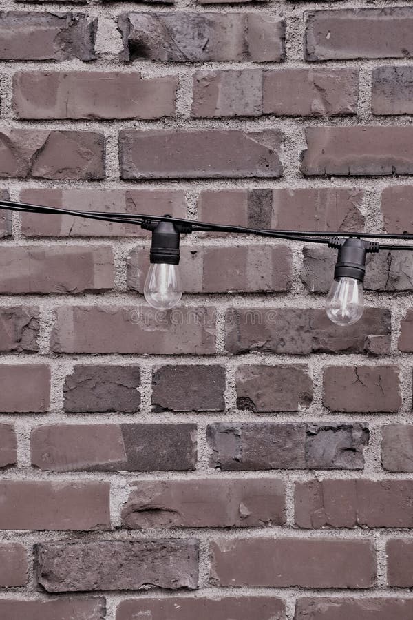Black Lightbulb String on Muted Red Brick Stock Photo - Image of facade ...