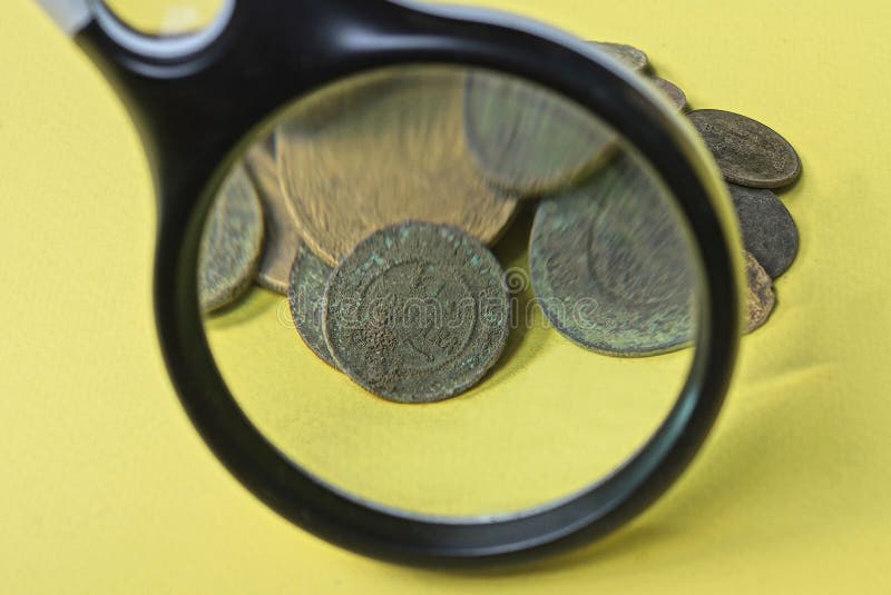 A Black Magnifying Glass Magnifies a Pile of Old Coins Stock Image ...