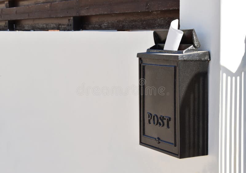 Black Mailbox in Front of a House with Shadow and Sunlight. Stock Image ...