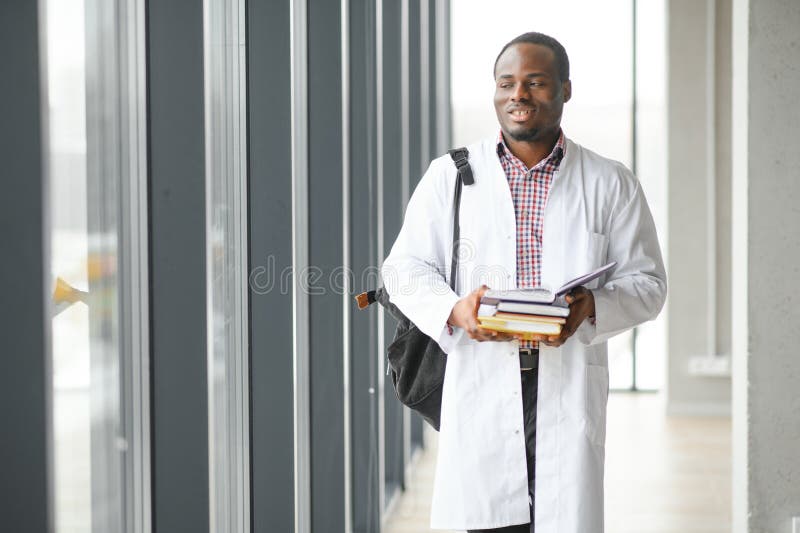 Black Male Doctor Student Wearing a Lab Coat with Book Stock Photo ...