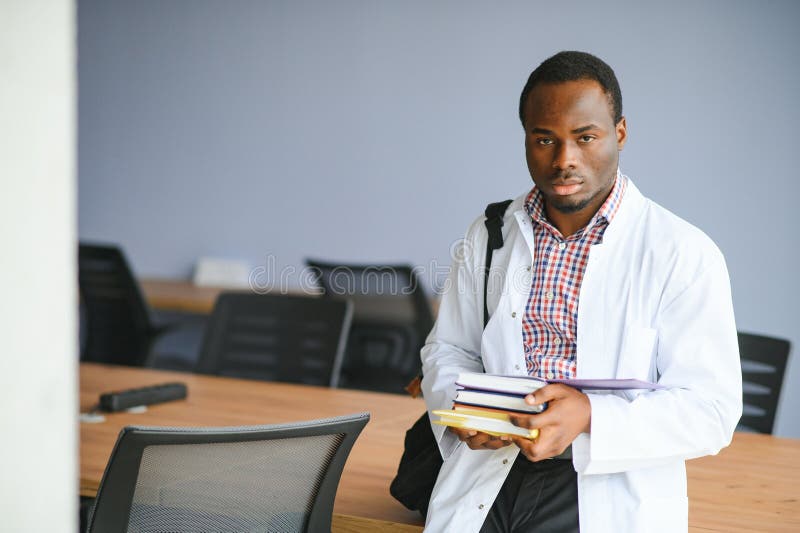 Black Male Doctor Student Wearing a Lab Coat with Book Stock Image ...