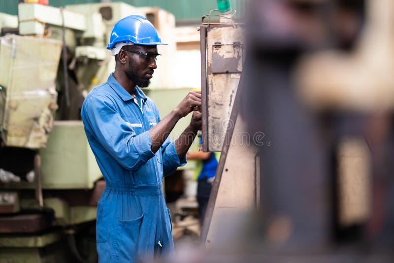 Black Male Engineer Working on Machine in Factory. Black Man Engineer ...