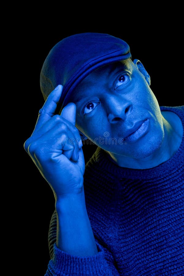 Black Man with Blue and Yellow Light, Wearing a Flat Cap Stock Photo ...