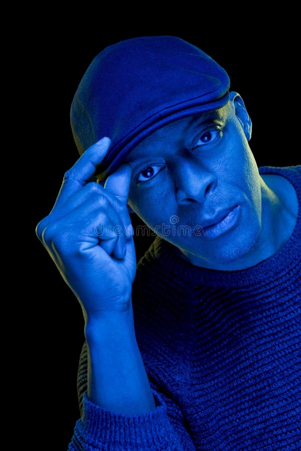Black Man with Blue and Yellow Light, with Hand on the Flat Cap ...