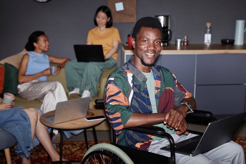 Black Man with Disability Smiling at Camera in Modern Office Lounge ...
