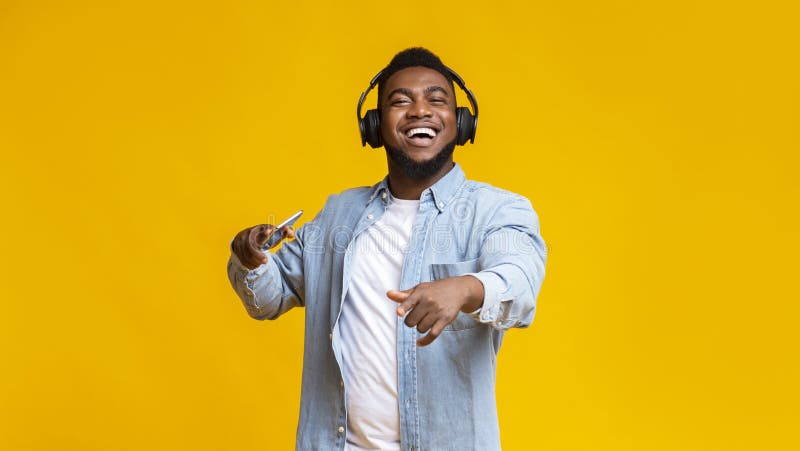 Black Man Enjoying Listening His Favorite Music In Headphones Stock