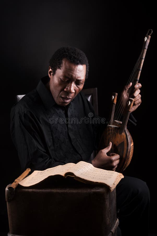 African Black Man with Ethnic Musical Instrument Stock Image - Image of ...