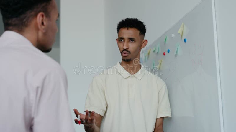A Black Man Explaining the Strategy of Drawing on a White Board in the ...