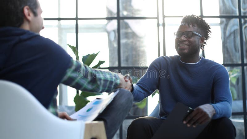 A Black Man with a Folder in His Hands Shakes Hands Stock Image - Image ...