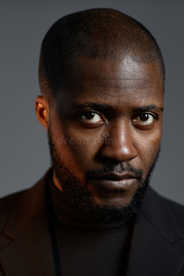 Black Man Looking at Camera Posing Against Gray Background in Studio ...