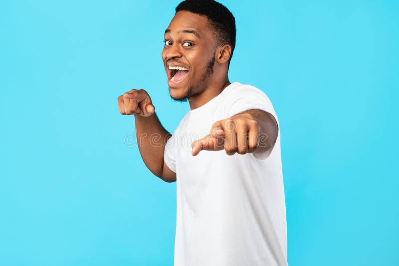 Black Man Pointing Fingers at Camera Over Blue Studio Background Stock ...