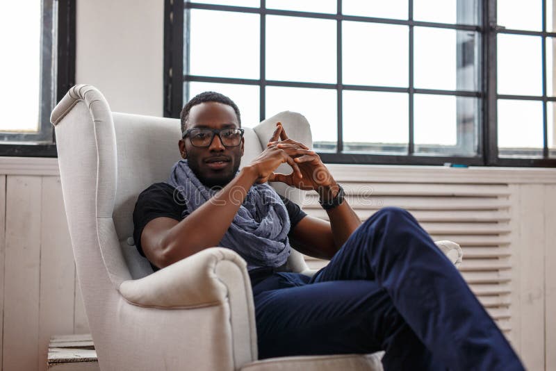 A Black Man Relaxing in a White Chair. Stock Image - Image of cheerful ...