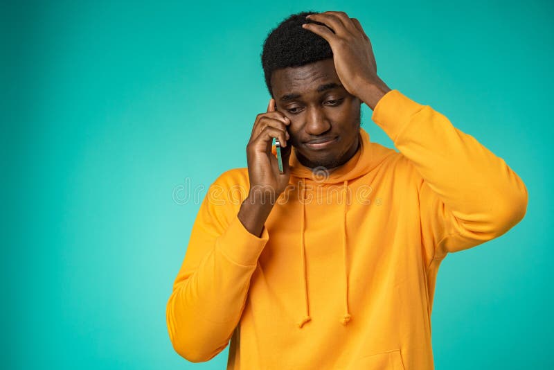 Black Man with a Sad Face Talking on the Phone in Studio Stock Image ...