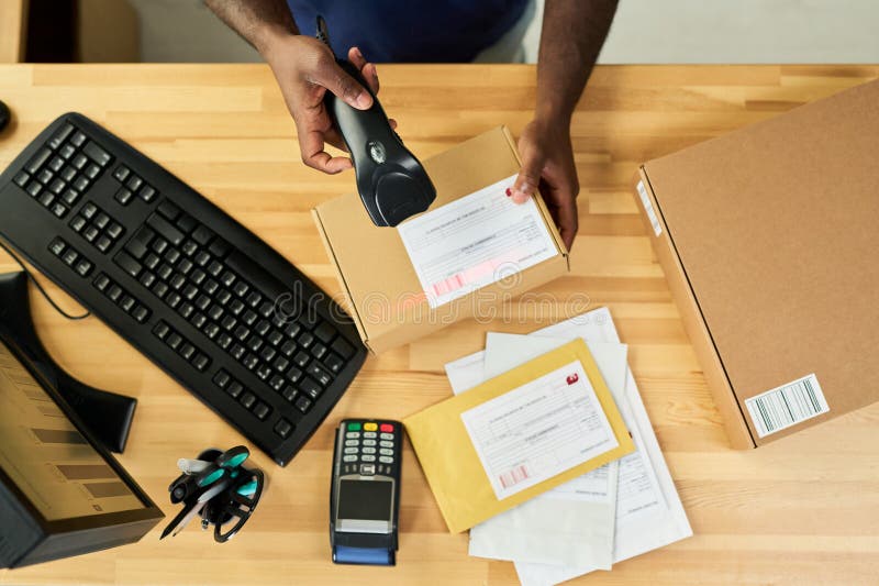 Young Adult Black Man Scanning Parcel Label while Working at Shipping ...