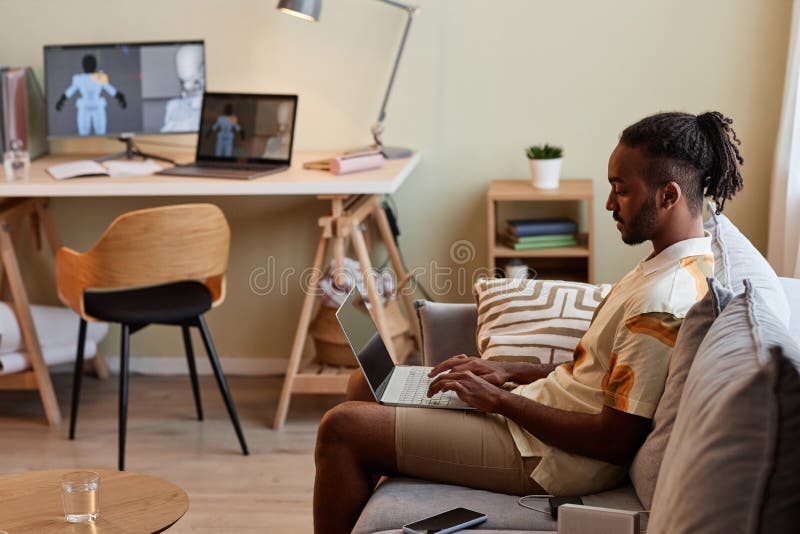Black Man Using Laptop while Sitting on Sofa Stock Image - Image of ...
