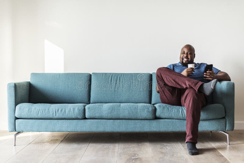 Black Man Using Mobile Phone on Couch Stock Image - Image of internet ...