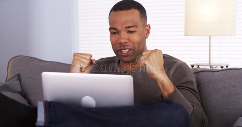 Black Man Watching the Game on His Laptop Stock Photo - Image of ...