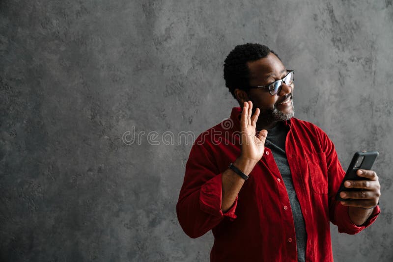 Black Man Waving Hand and Using Cellphone Indoors Stock Photo - Image ...