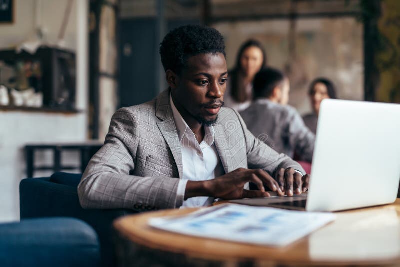 Black Man Working on His Laptop while Sitting in Cafe Stock Photo ...