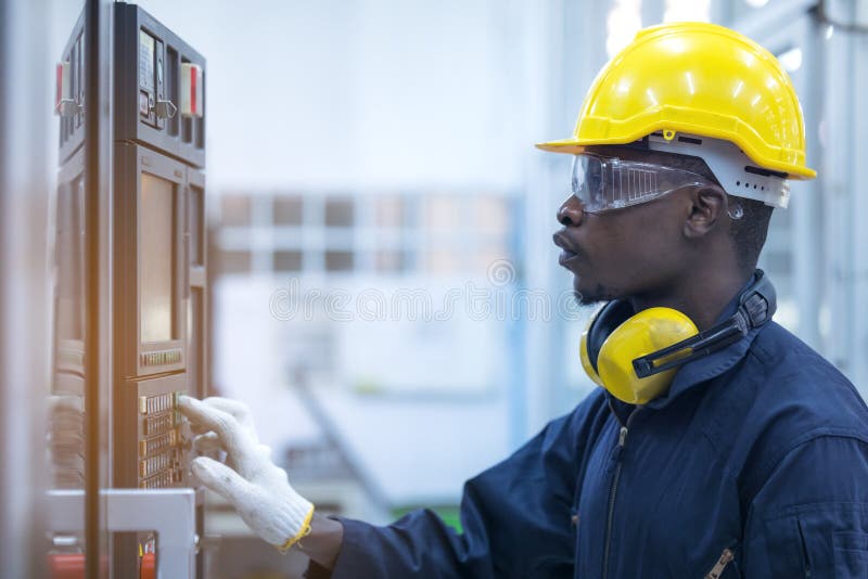 Black Man Working at Programmable Machine in Factory Industries Stock ...
