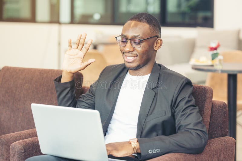 A Black Man Works on a Tablet Computer in the Hotel Lobby Stock Image ...