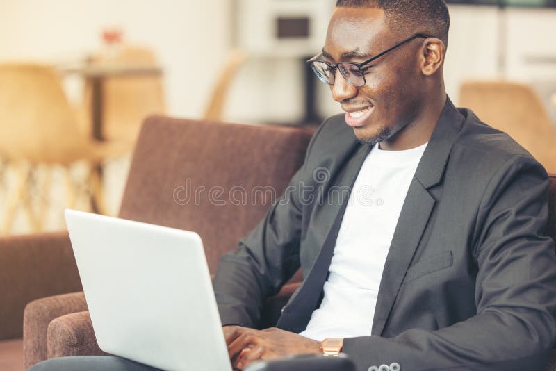 A Black Man Works on a Tablet Computer in the Hotel Lobby Stock Photo ...